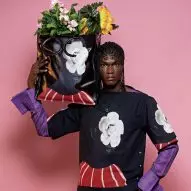 Modell som håller en väska med blommor i från SS22 lookbook av Orange Culture, som fotograferad av Jolaoso Wasiu Adebayo