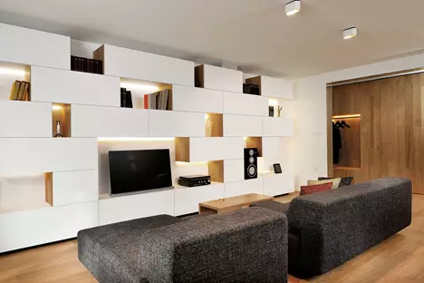 Studio 360 додає стіни модульних стелажів і сховищ до словенської квартири