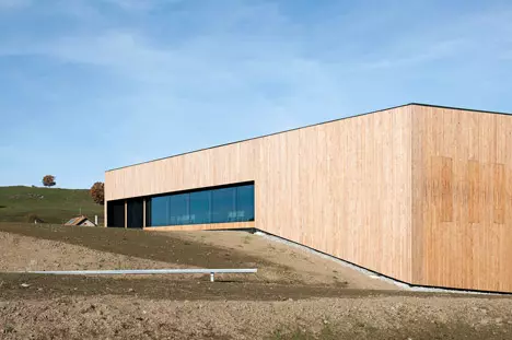 Holzwände weisen schmale vertikale Schnitte in der Lussy Sports Hall von Virdis Architecture auf